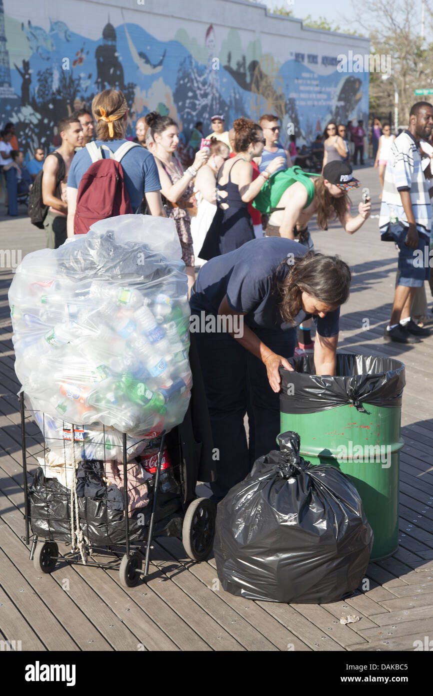 Poor person scrounging for cans and bottles on the boardwalk at Coney ...