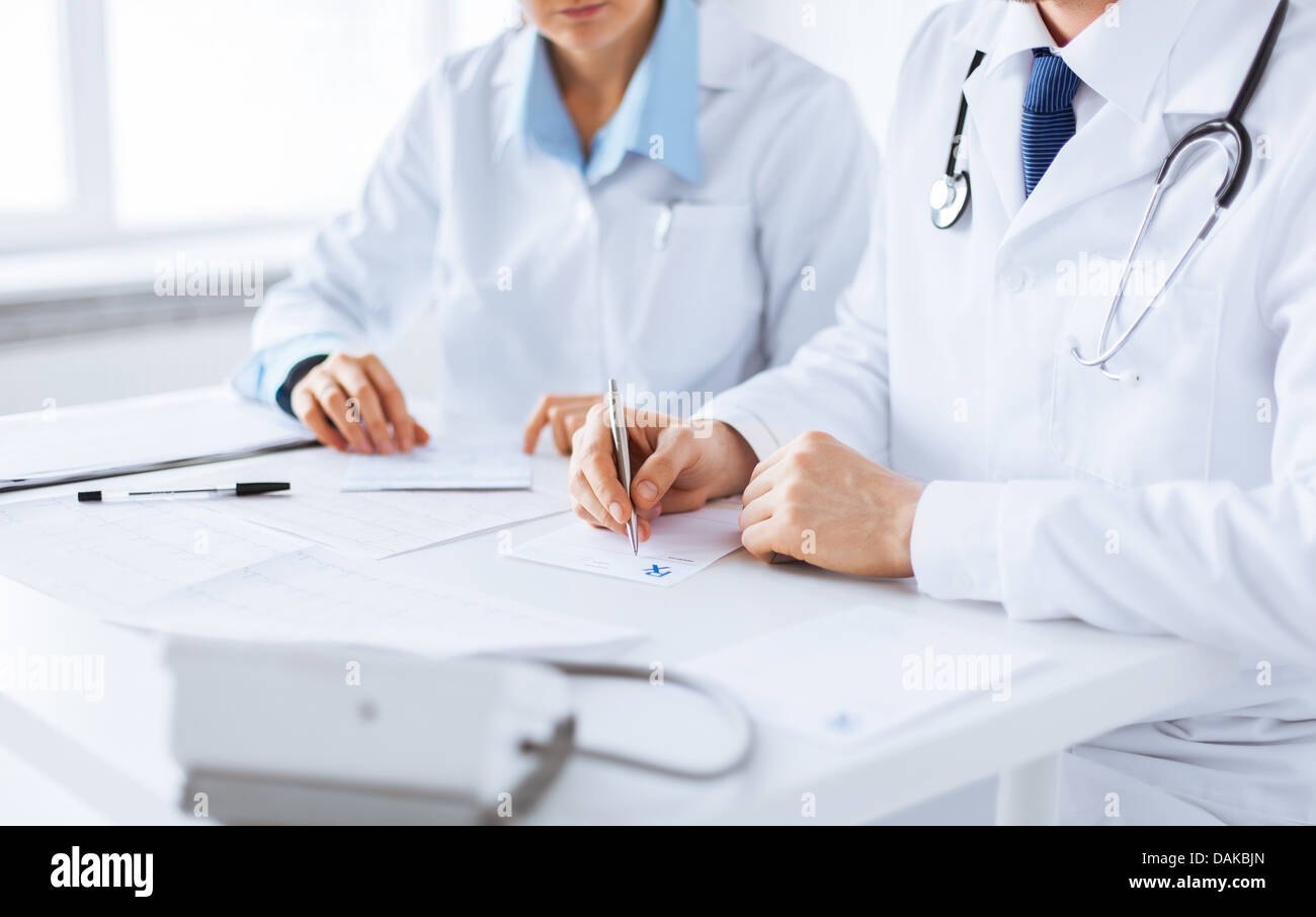 doctor and nurse writing prescription paper Stock Photo - Alamy