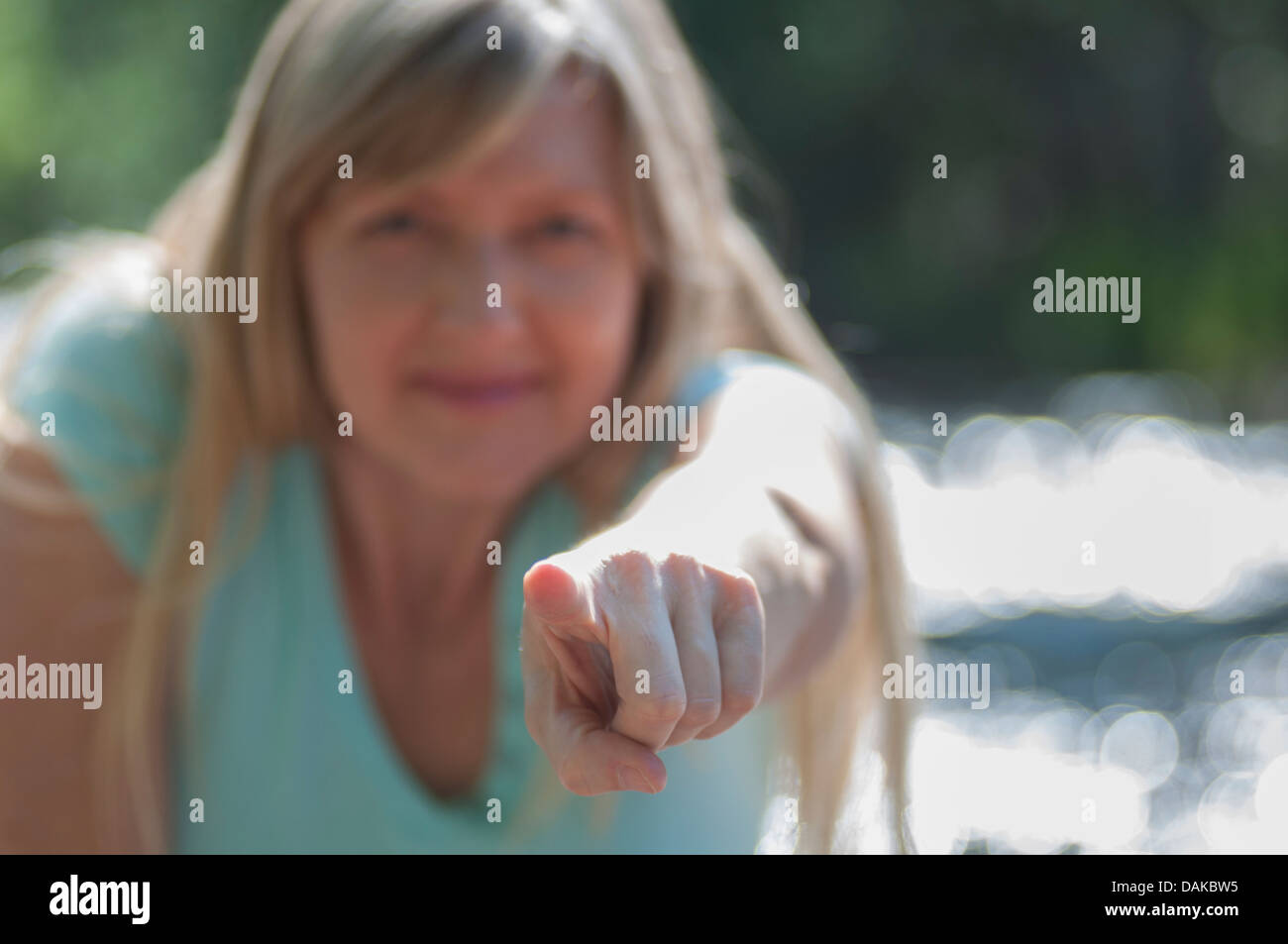 Closeup of blond woman pointing at the camera Stock Photo - Alamy