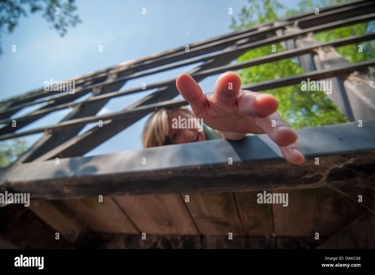 Woman extending hand from bridge Stock Photo - Alamy