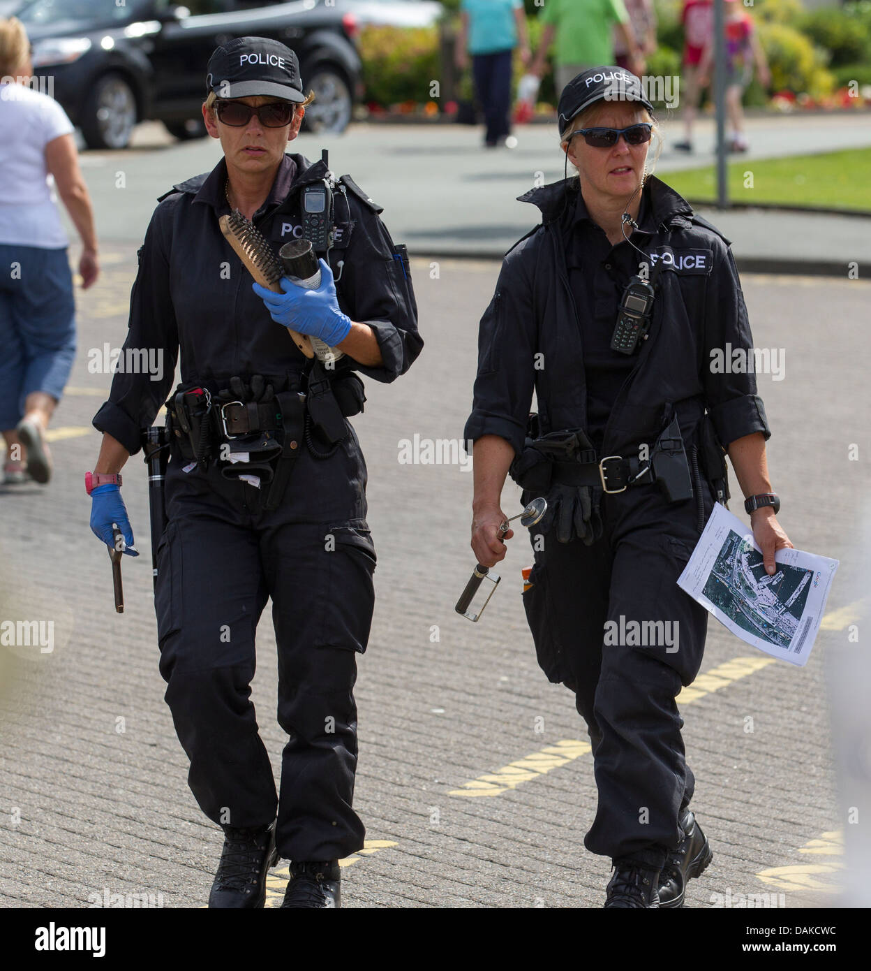 Police security female officers checking for bombs - explosives before ...