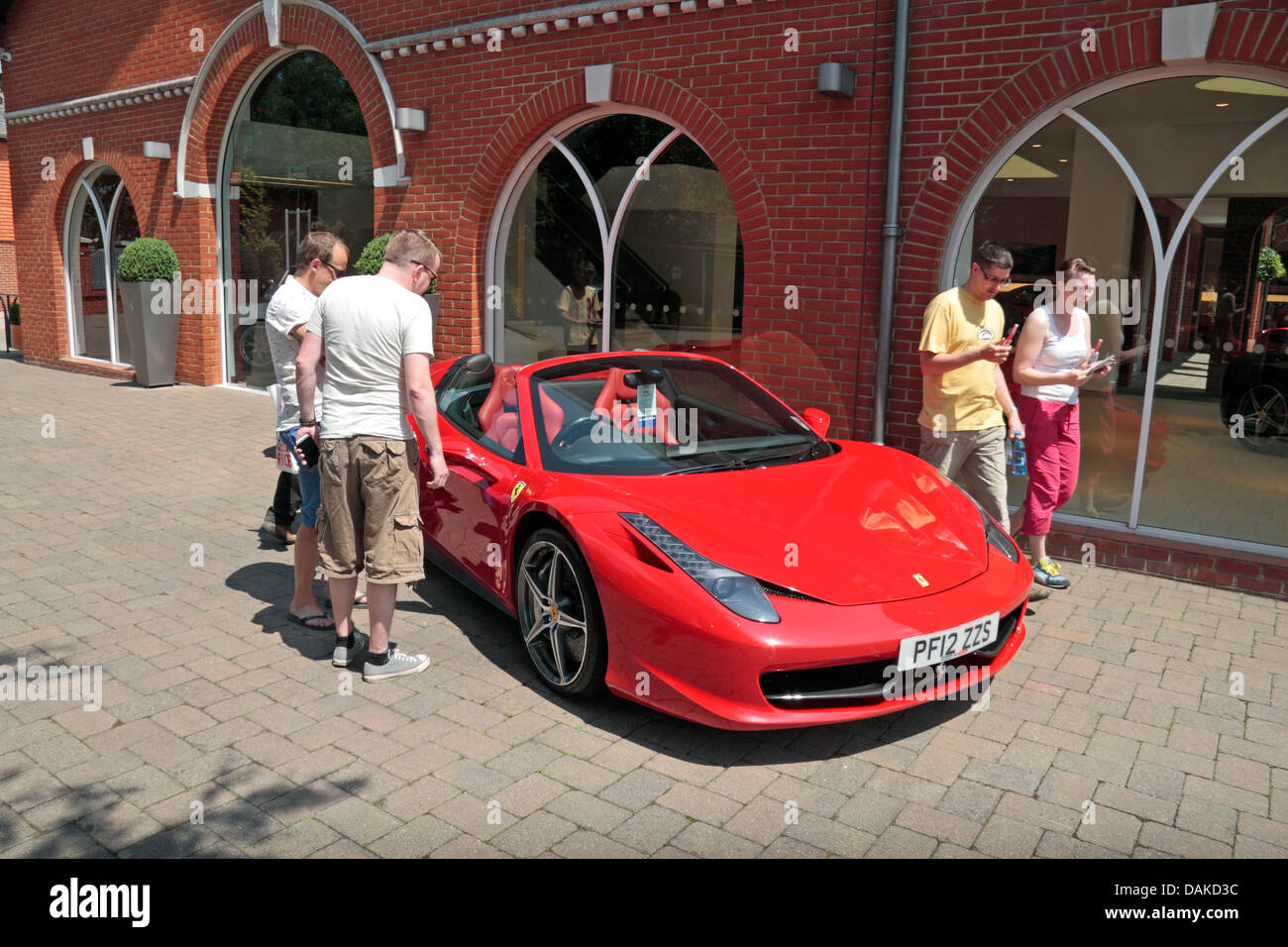 People admiring a Ferrari 458 Spider 2012 '12' outside Meridien Modena ...