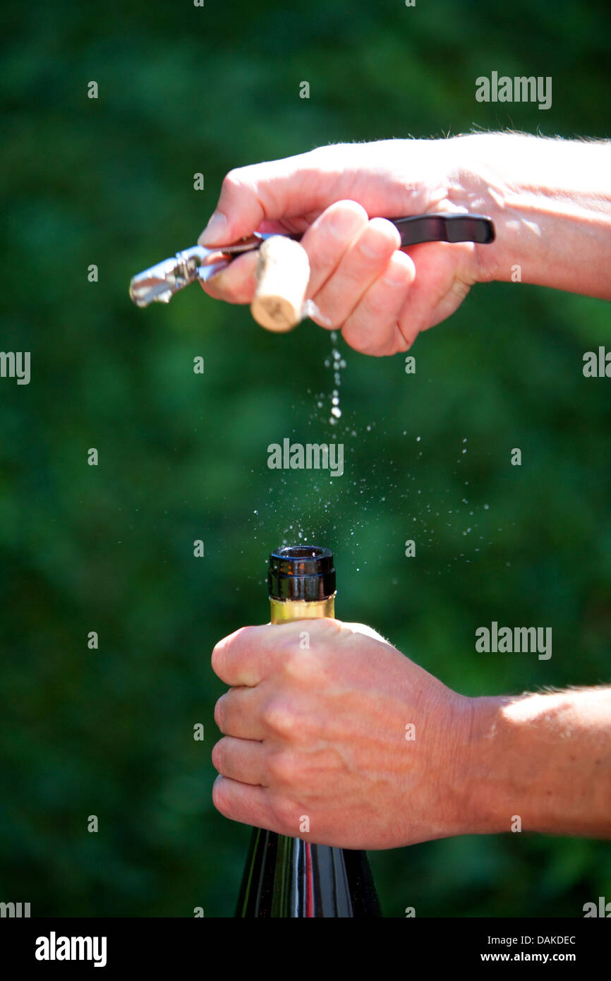 uncorking of a bottle of wine Stock Photo - Alamy