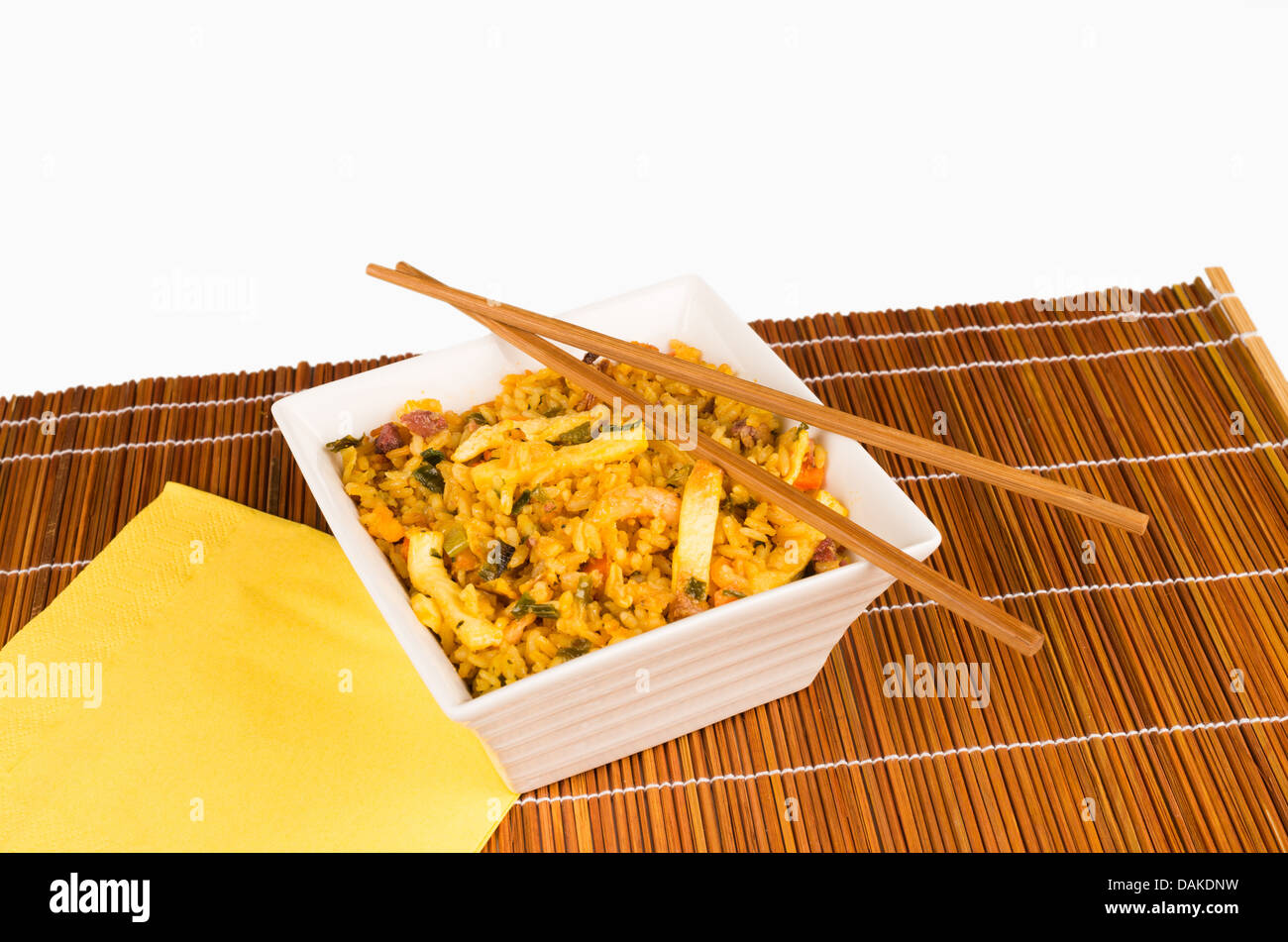 Bowl with Singapore rice on a bamboo mat Stock Photo - Alamy