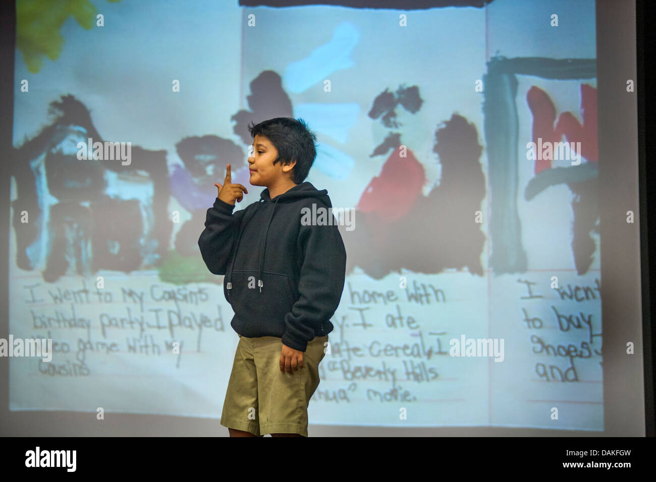 A deaf child uses sign language to "read" the composition he has ...