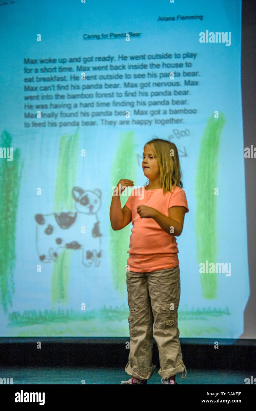A deaf girl uses sign language to 