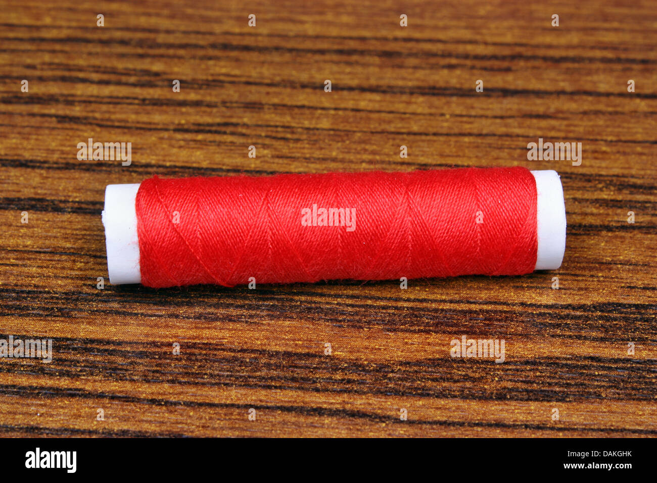 Red sewing thread Stock Photo - Alamy