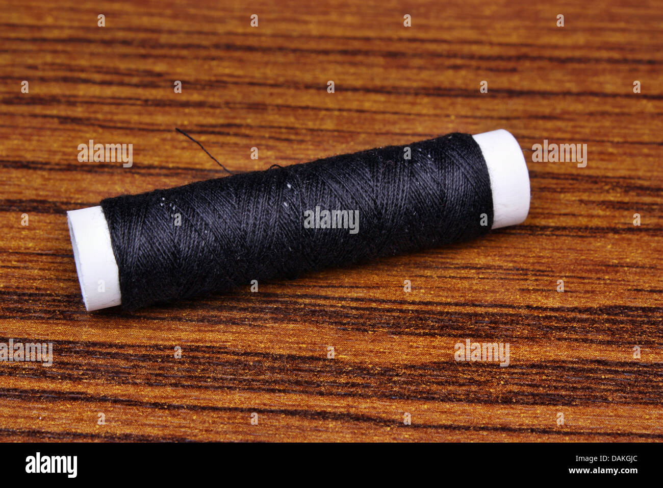 Black sewing thread Stock Photo - Alamy