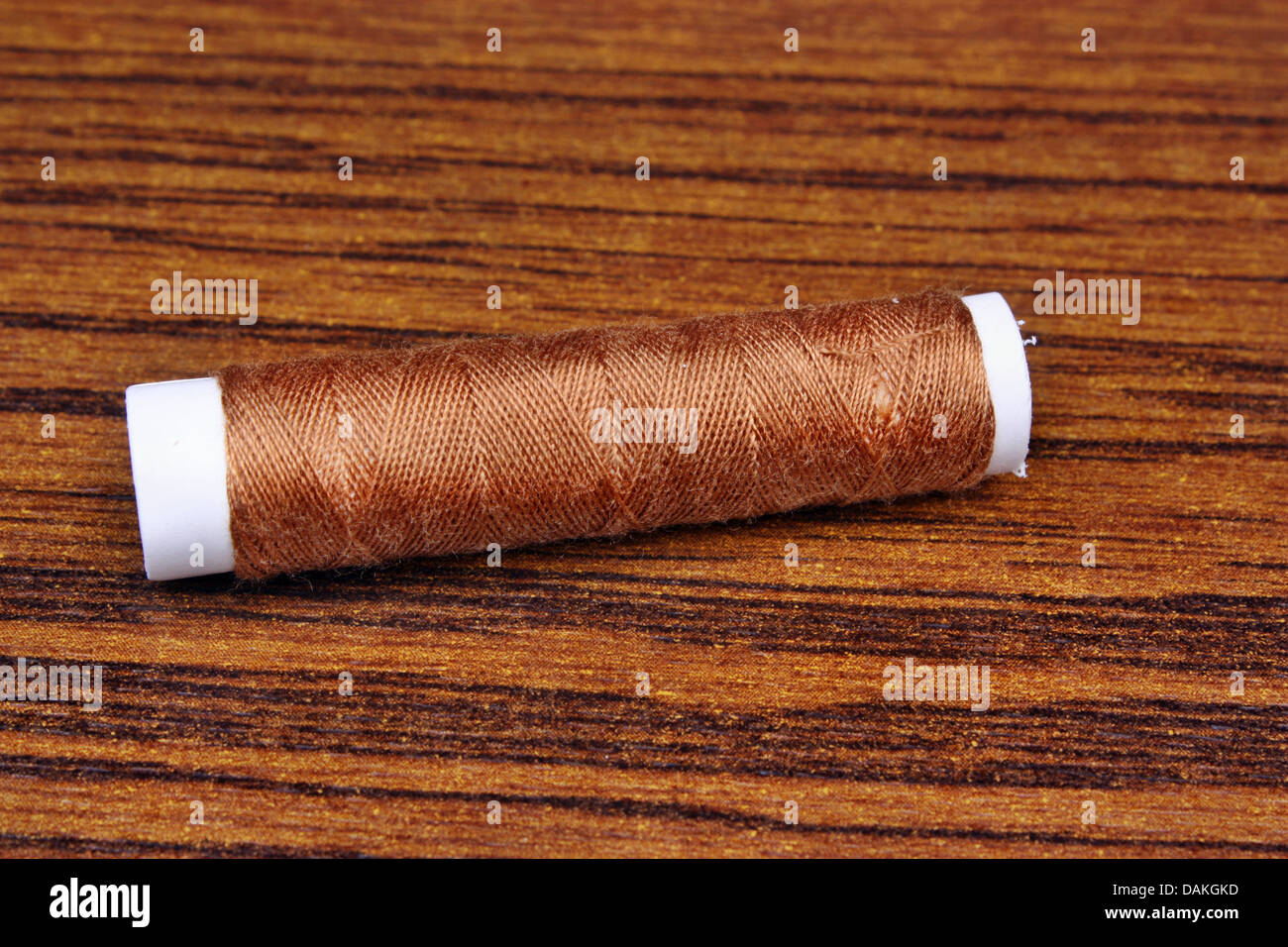 Brown sewing thread Stock Photo - Alamy