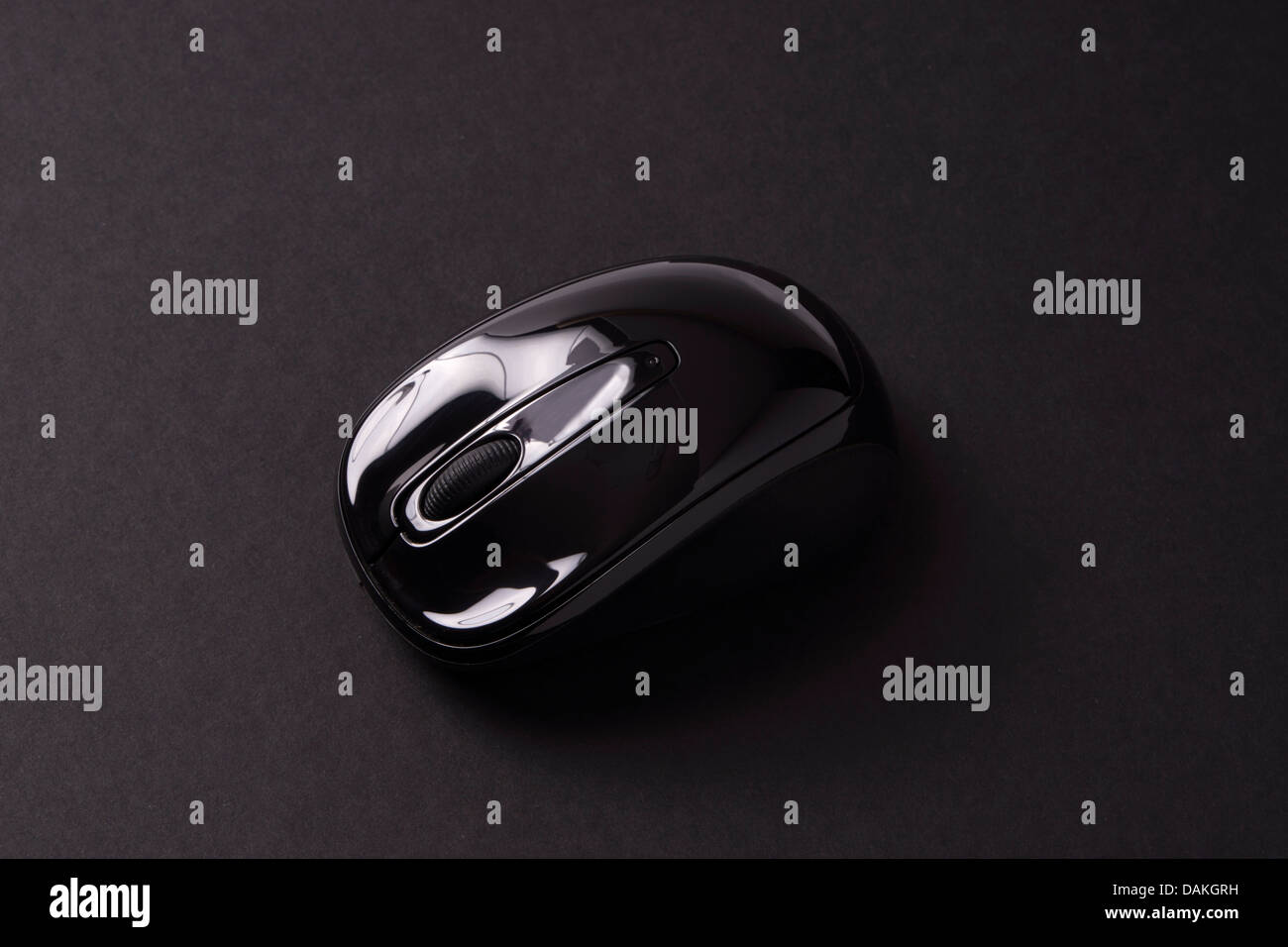 Black wireless computer mouse on a dark gray background Stock Photo - Alamy