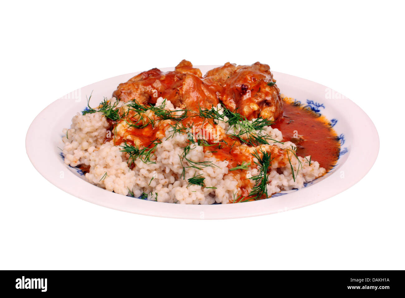 Meat and grits topped with sauce Stock Photo - Alamy