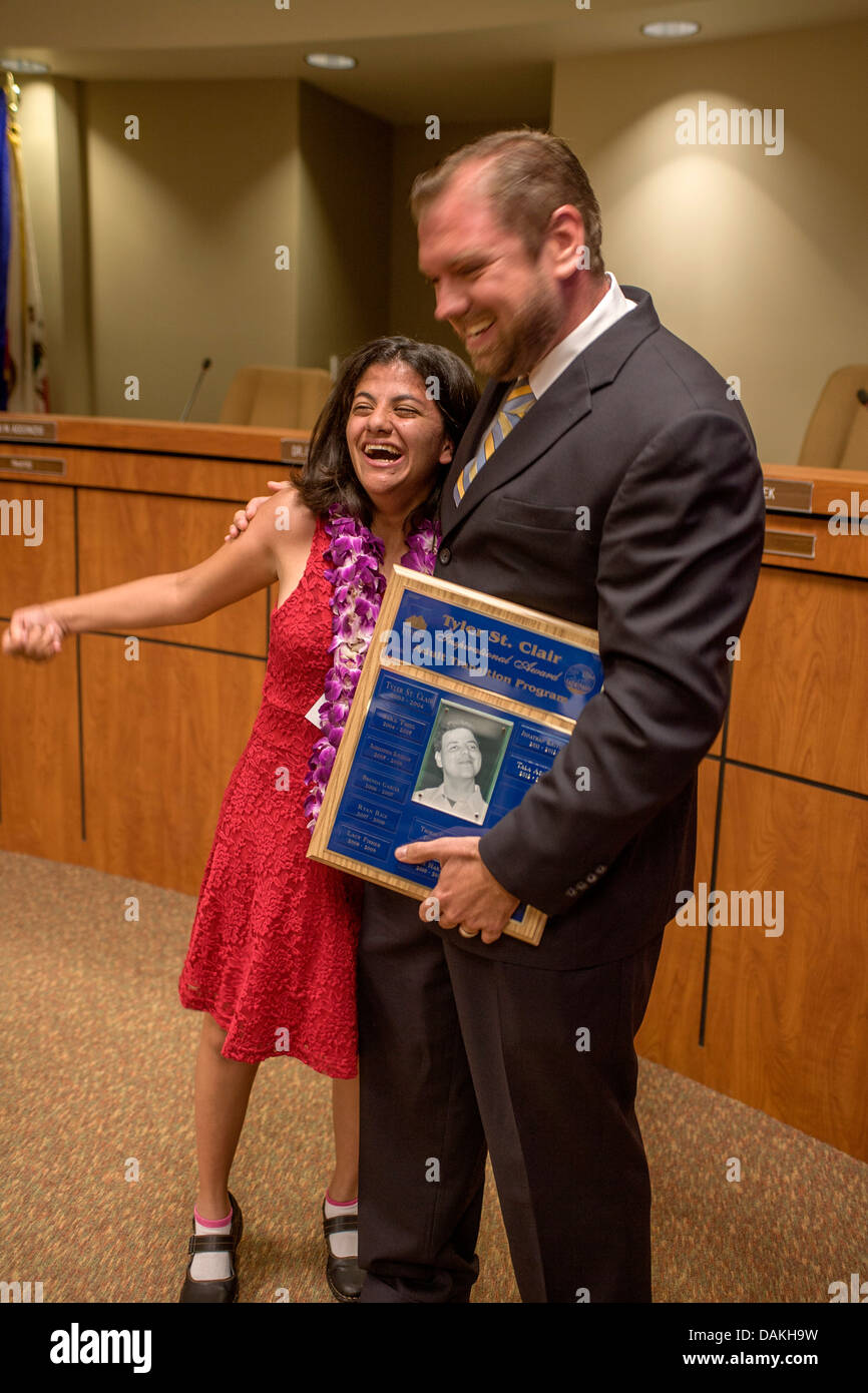 A happy graduate receives her diploma at her Adult Transition Program ...