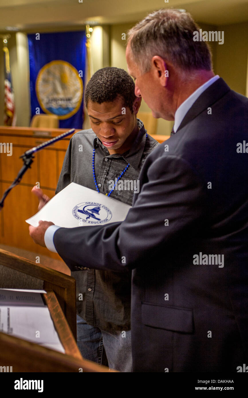 A happy graduate receives a special award at his Adult Transition ...