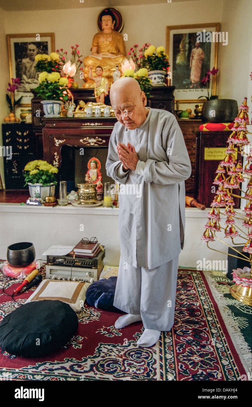 A Vietnamese Buddhist priest poses in his makeshift temple located in a ...