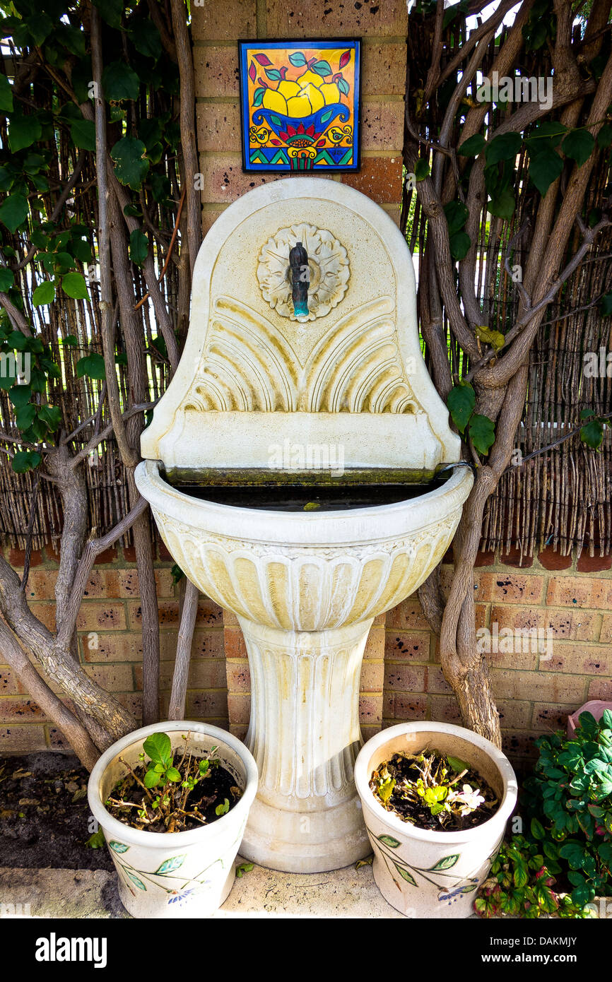 A tap water fountain in a landscape garden Stock Photo - Alamy