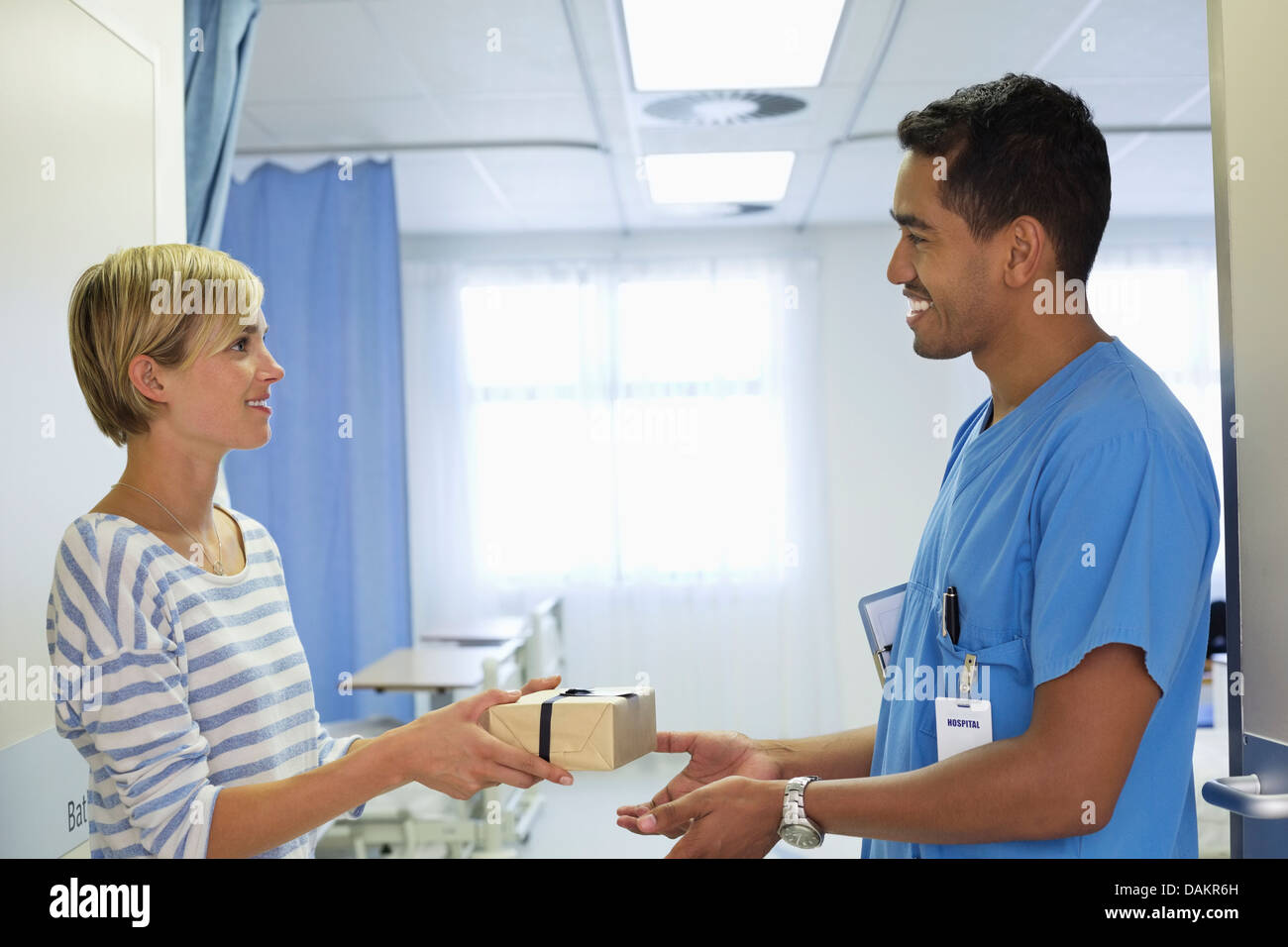 Patient giving nurse gift in hospital Stock Photo - Alamy