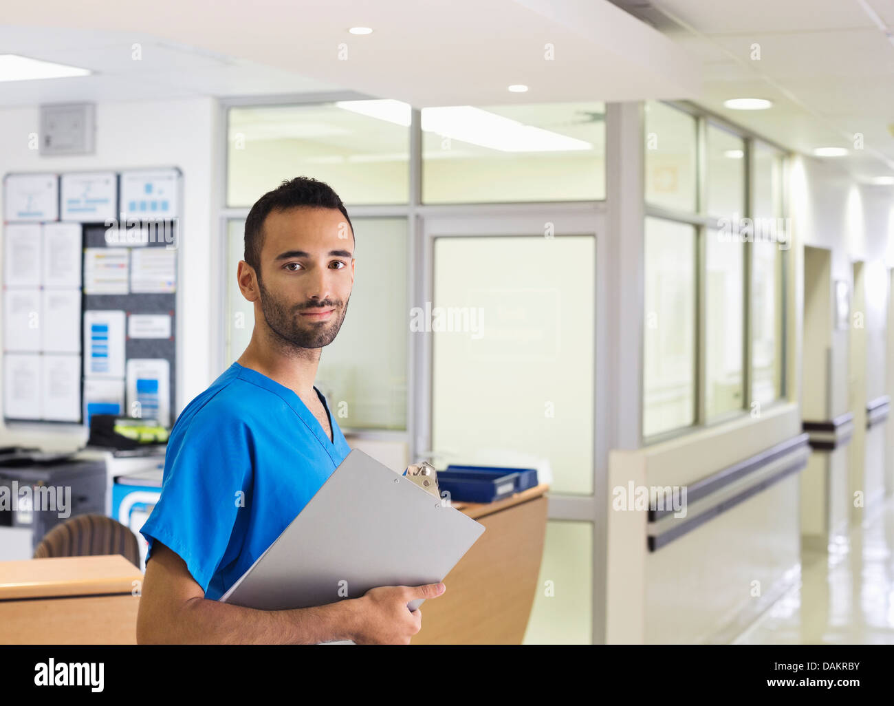 Nurse smiling in hospital hallway Stock Photo - Alamy