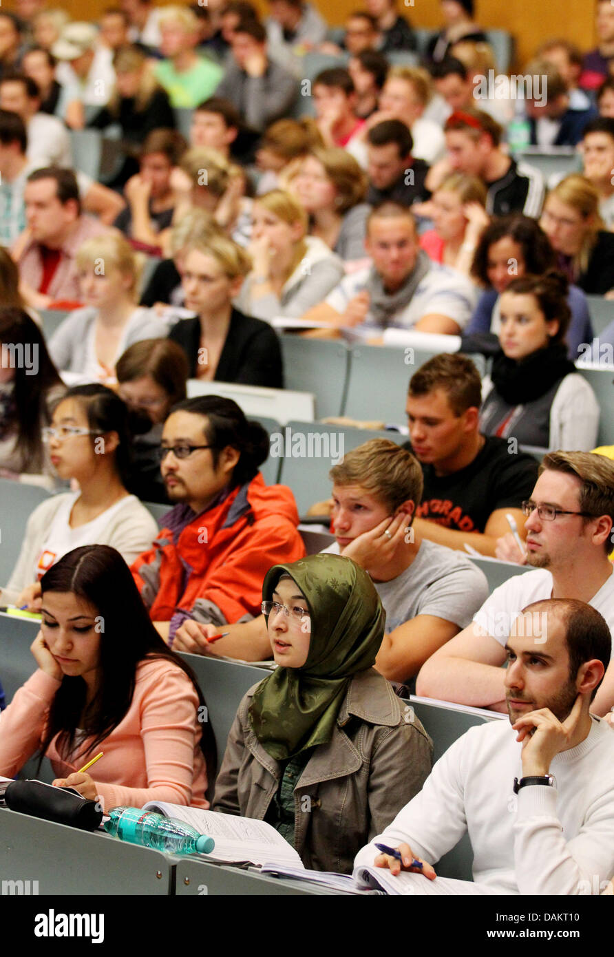 Students attend a lecture at a lecture hall of the university in ...