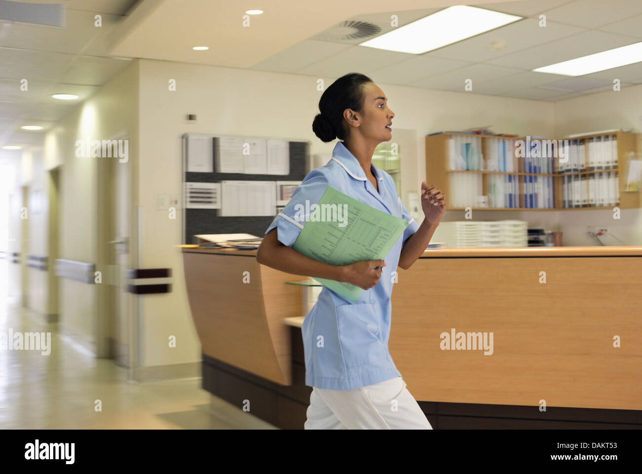 Nurse rushing in hospital hallway Stock Photo - Alamy