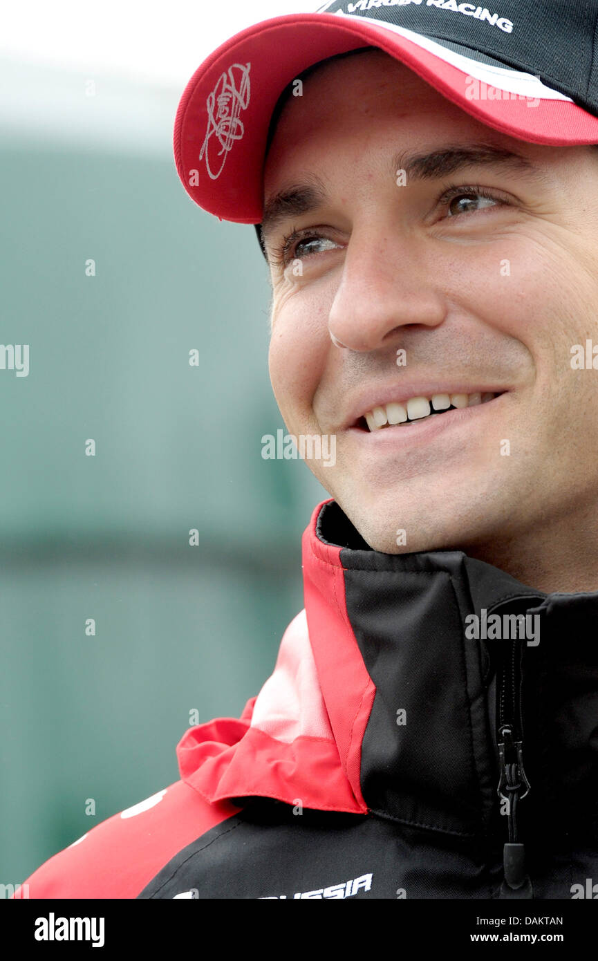 German Formula One driver Timo Glock of Virgin smiles in the paddock at ...