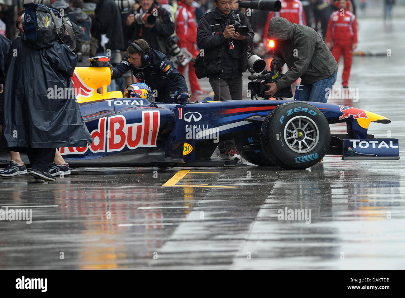 Mechanics push back the racing car of German Formula One driver ...