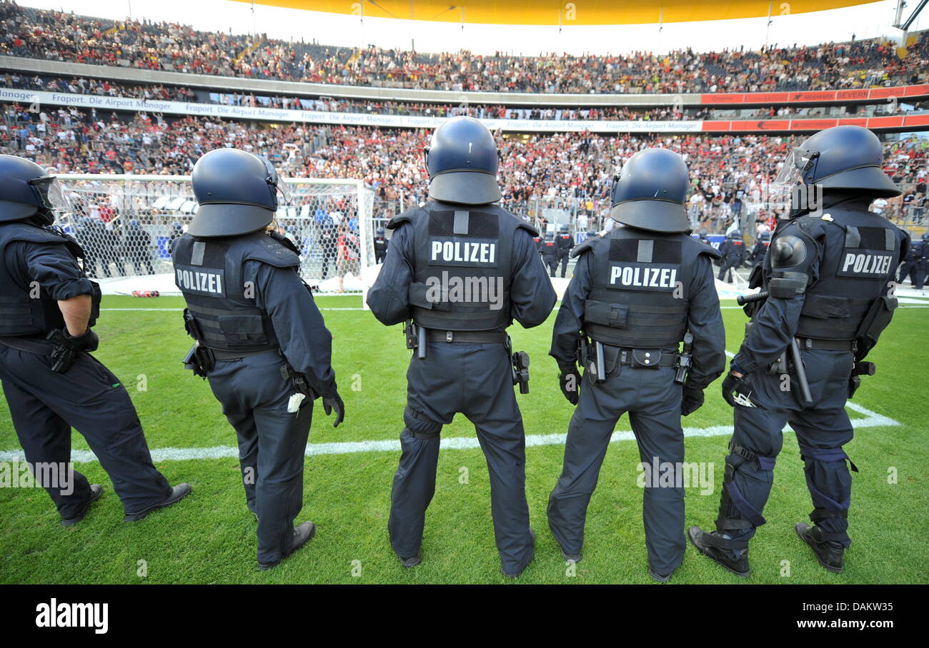 Uniformed police officers move against rioting fans of soccer club ...