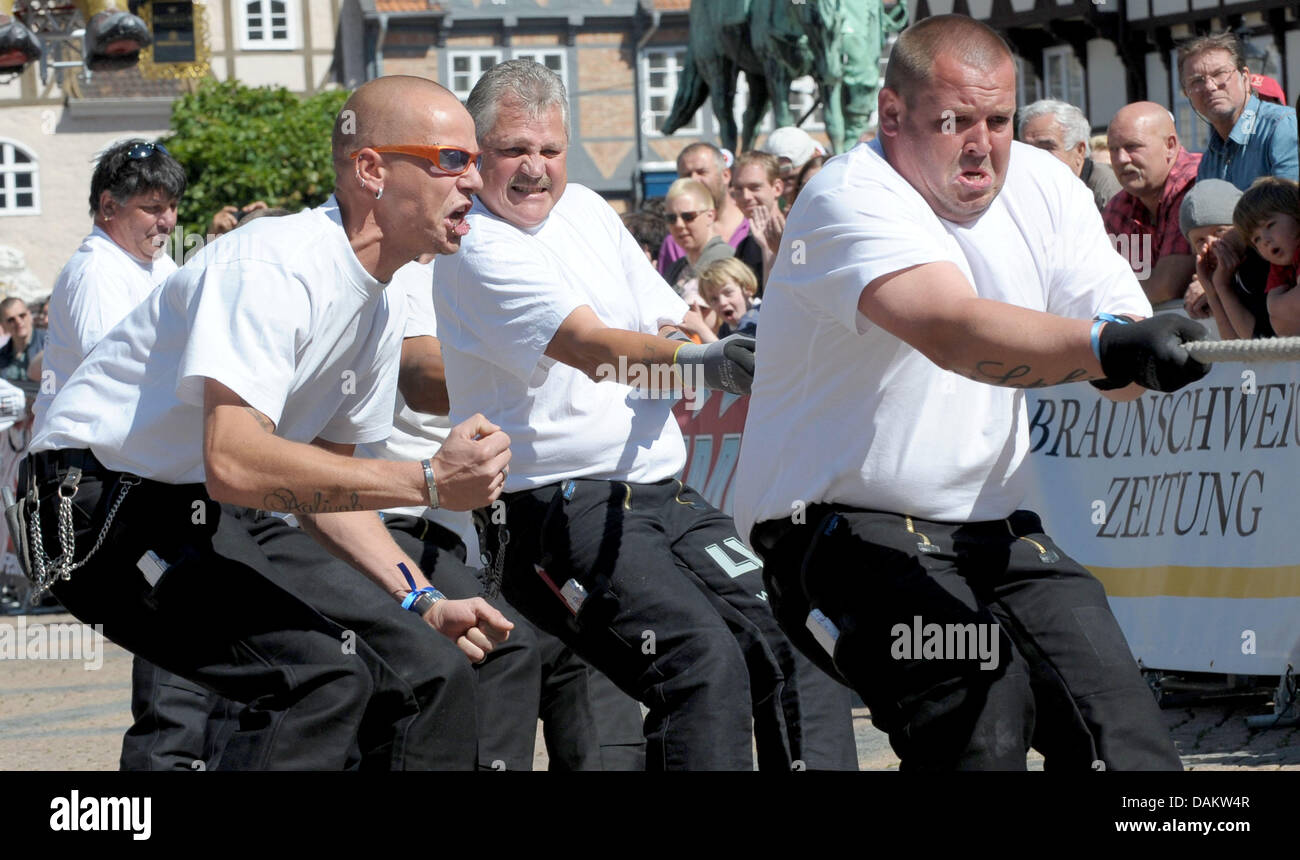 Participants of so called "bus pulling" pull a 16 ton heavy bus across ...