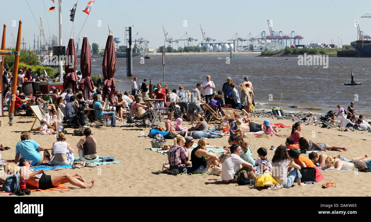 People are sunbathing at a beach on the Elbe River in Hamburg, Germany ...