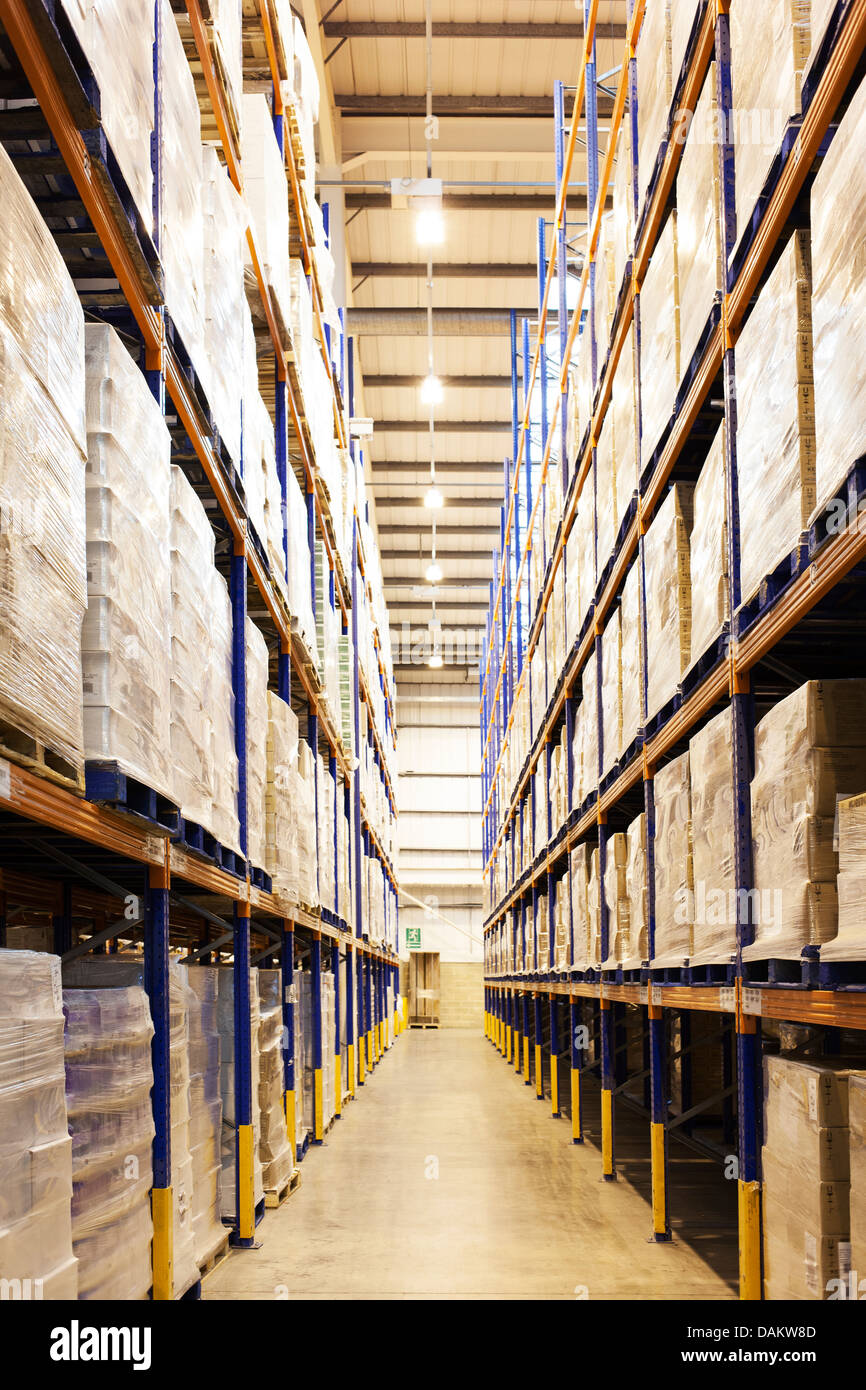 Aisle of boxes in warehouse Stock Photo - Alamy