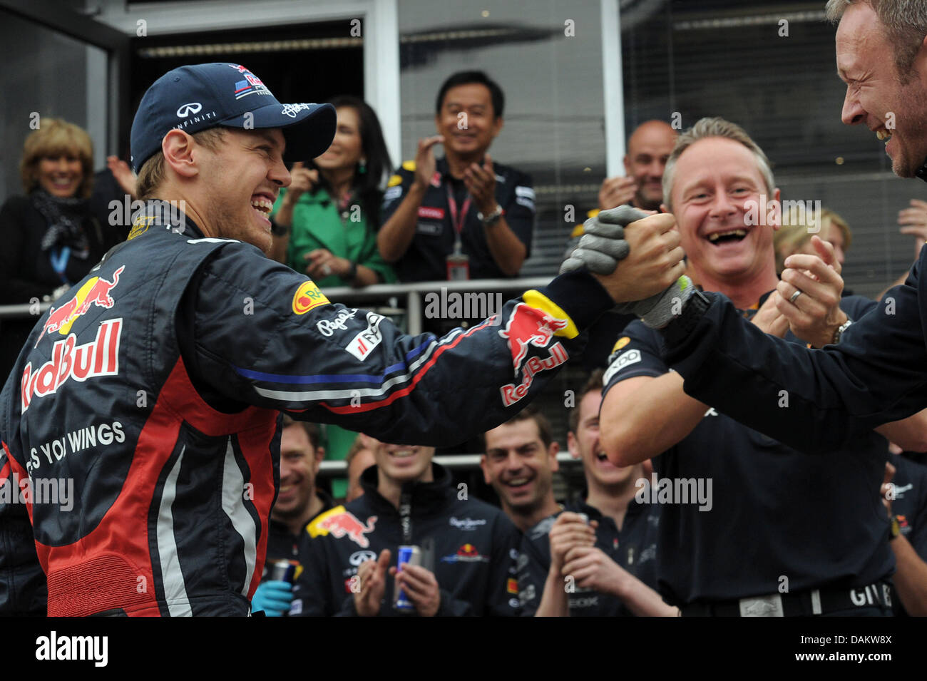 German Formula One driver Sebastian Vettel (L) of Red Bull celebrates ...