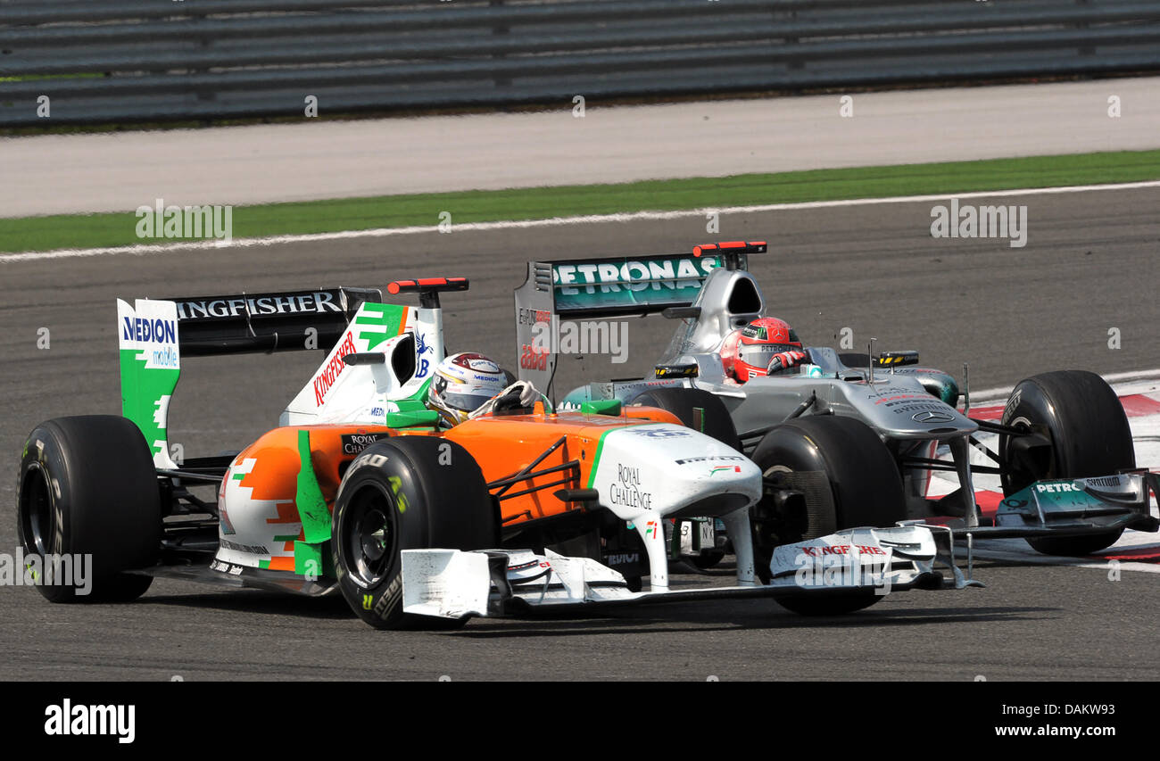 German Formula One driver Michael Schumacher (R) of Mercedes GP tries ...