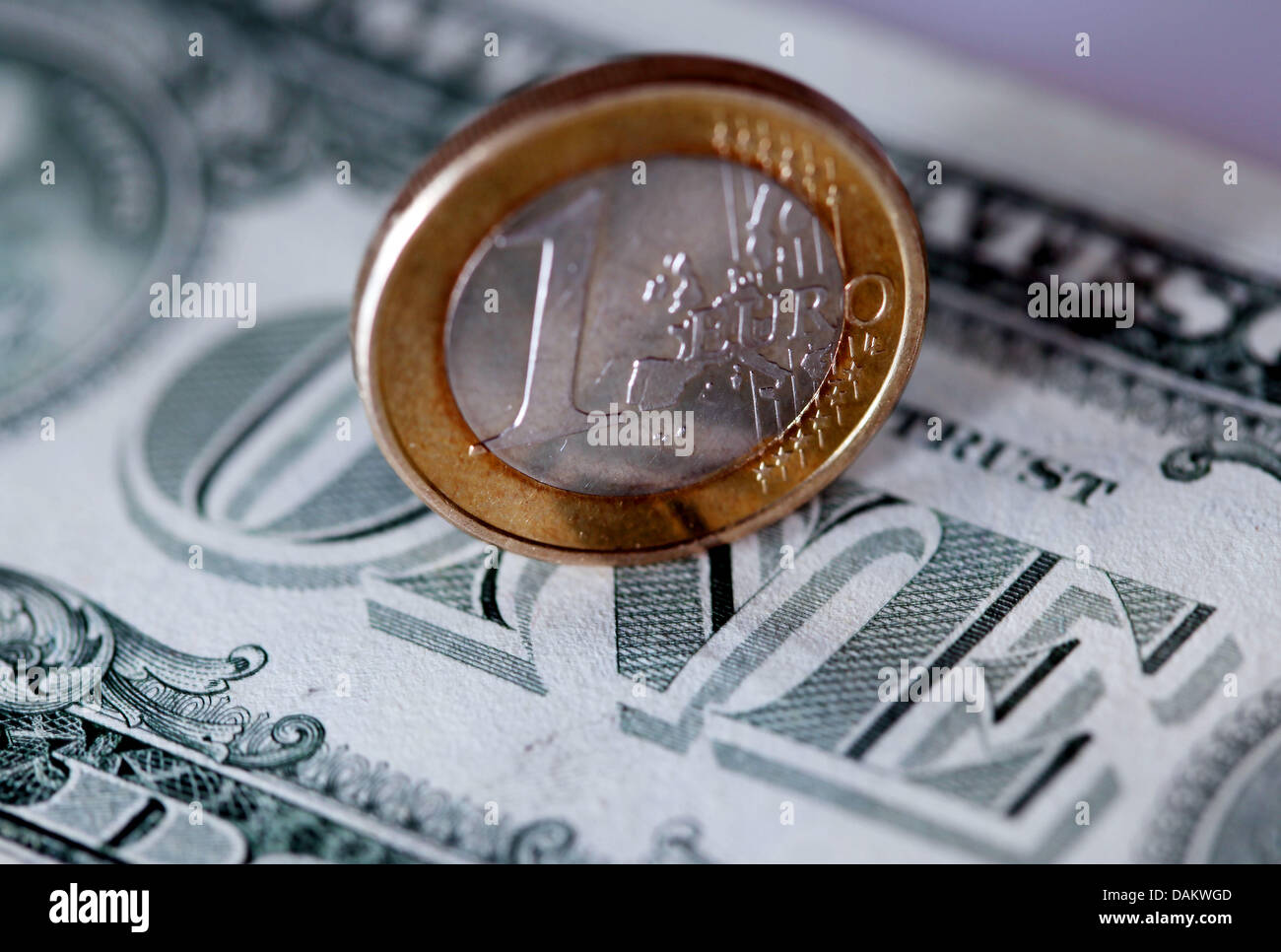ILLUSTRATION - A One-Euro-coin stands on a One Dollar note in Cologne ...