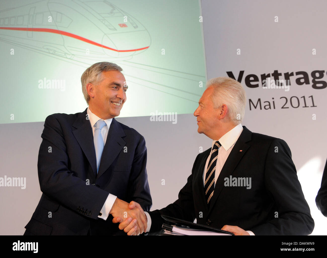 CEO of Siemens Peter Loescher (L) shakes hands with Railways Chief ...