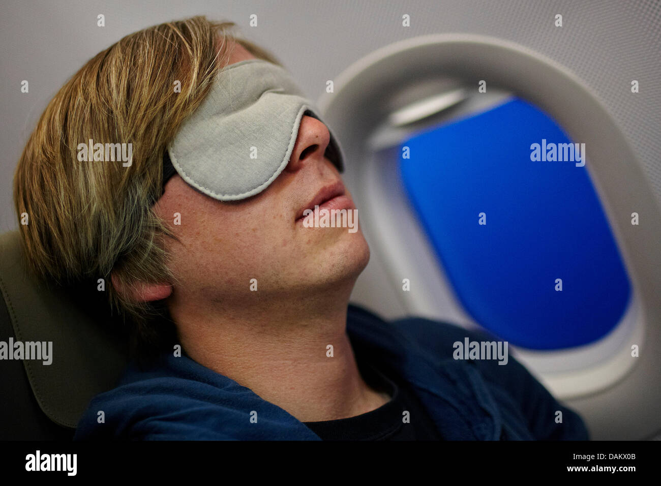 A man wears an eye mask on a plane in Hamburg, Germany, 30 April 2011 ...