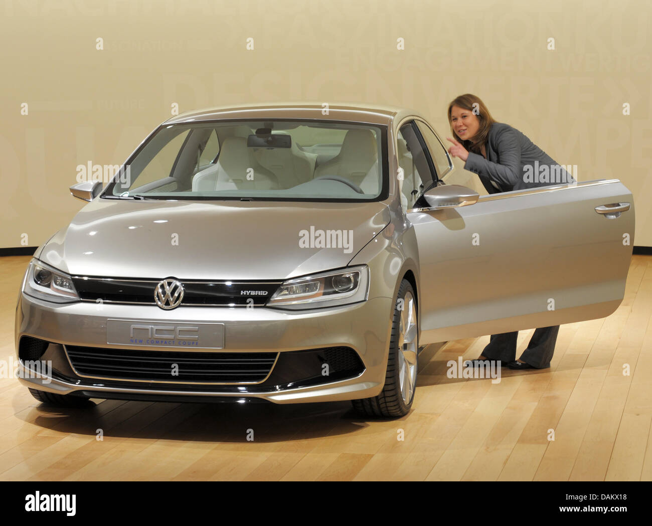 A visitor looks into the New Compact Coupe by Volkswagen at Glaeserne ...