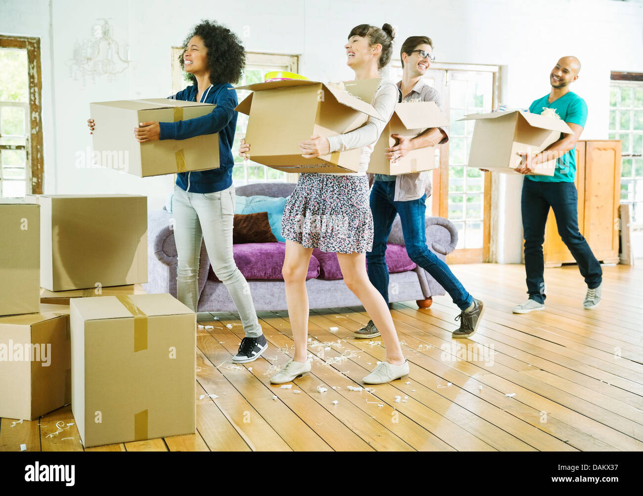 Friends unpacking boxes in new home Stock Photo - Alamy