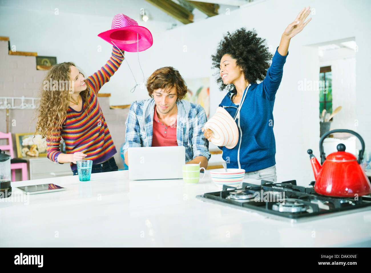 Friends playing in kitchen Stock Photo - Alamy
