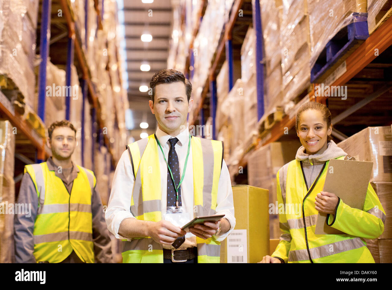 Workers standing in warehouse Stock Photo - Alamy
