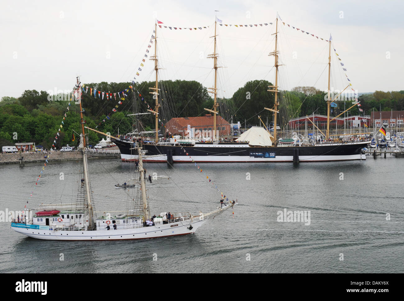 The sail training ship 'Greif' (L) passes the four-mast bark 'Passat ...