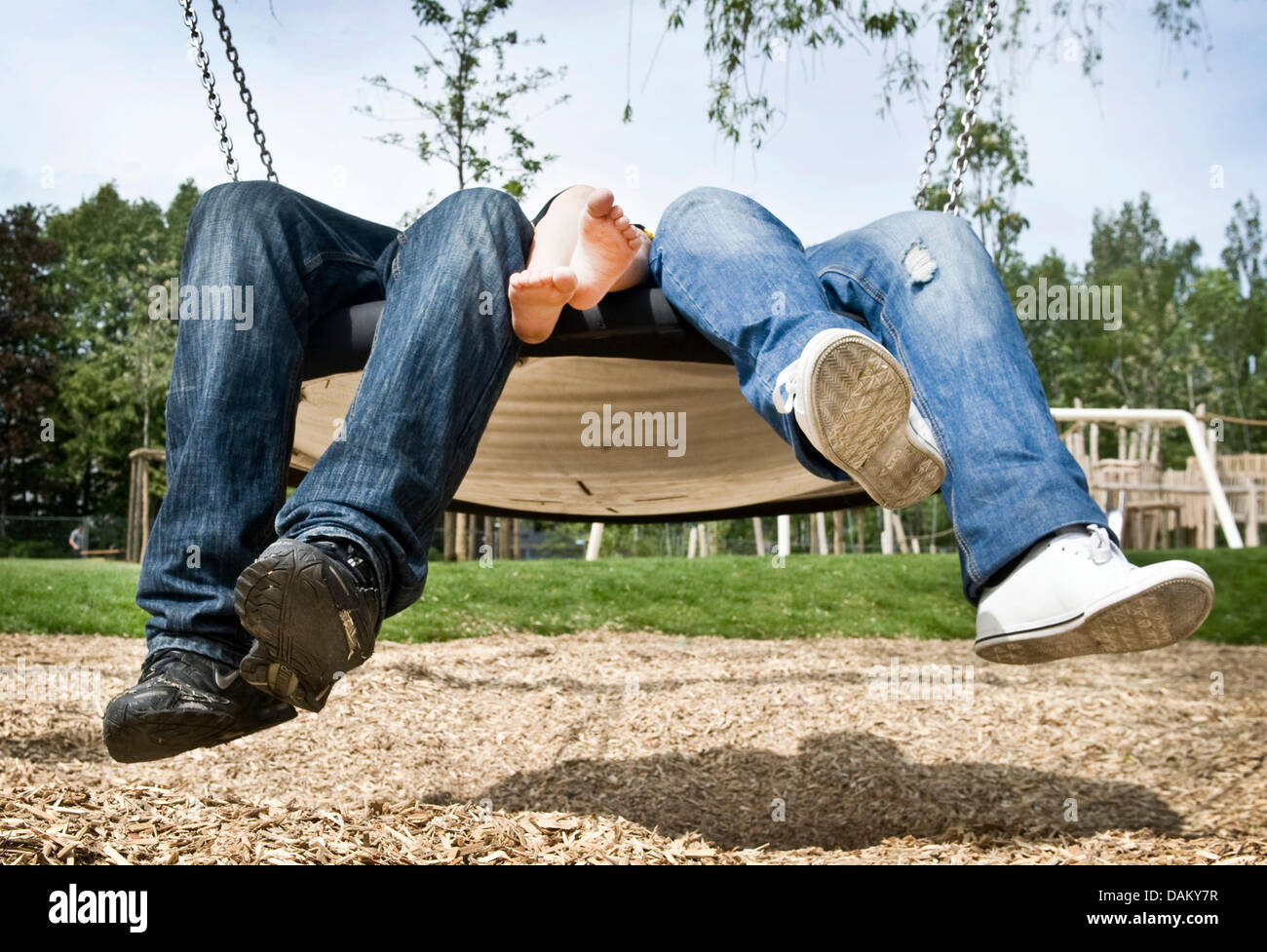 Two people lay on a swing at a playground in Mettmann, Germany, 9 May ...