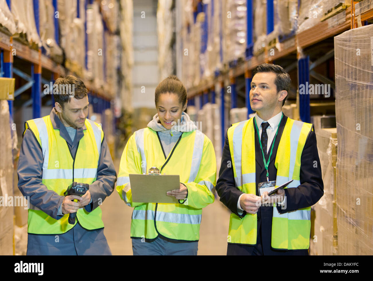 Workers talking in warehouse Stock Photo - Alamy