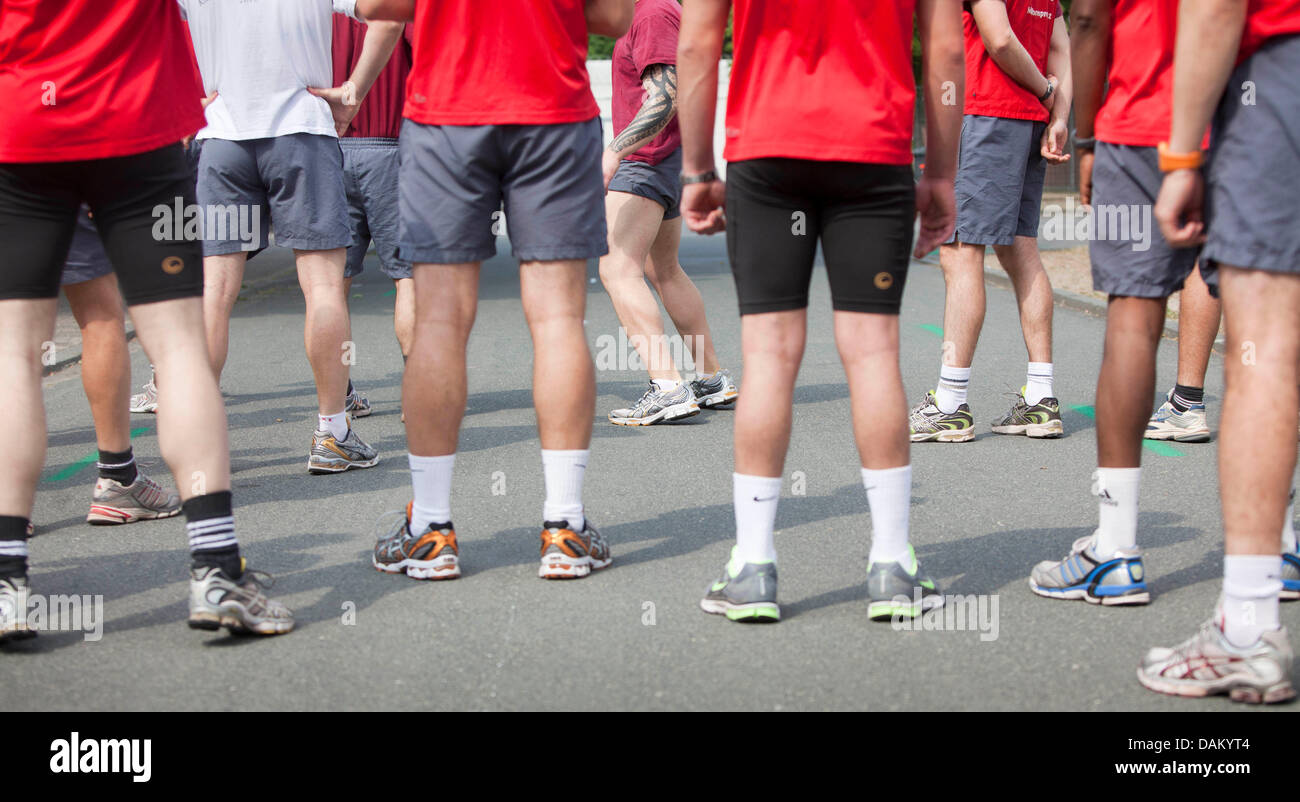 Inmates of the correctional facility run along the prison walls in ...