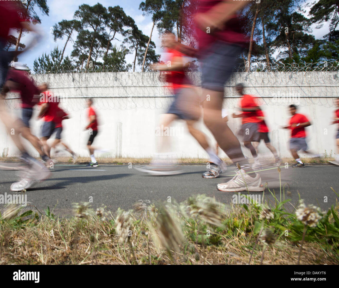 Inmates of the correctional facility run along the prison walls in ...