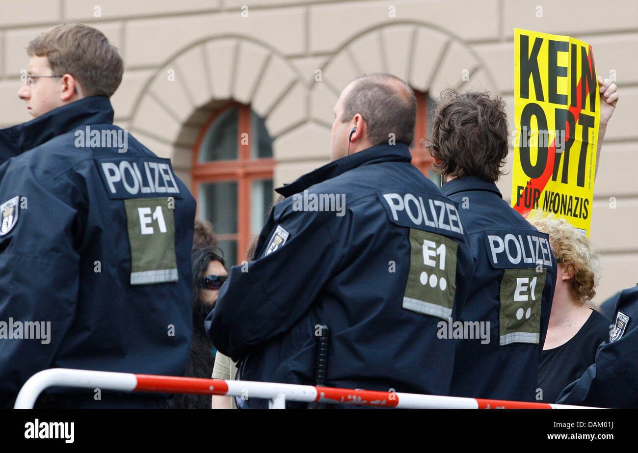 A sign reading "no place for nazis" is held high by ...