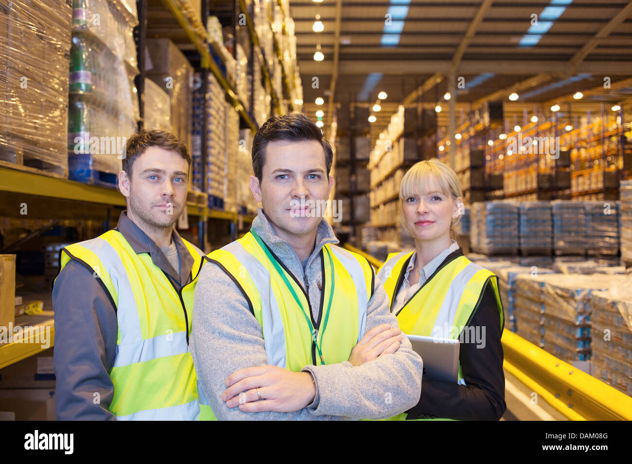 Workers smiling in warehouse Stock Photo - Alamy