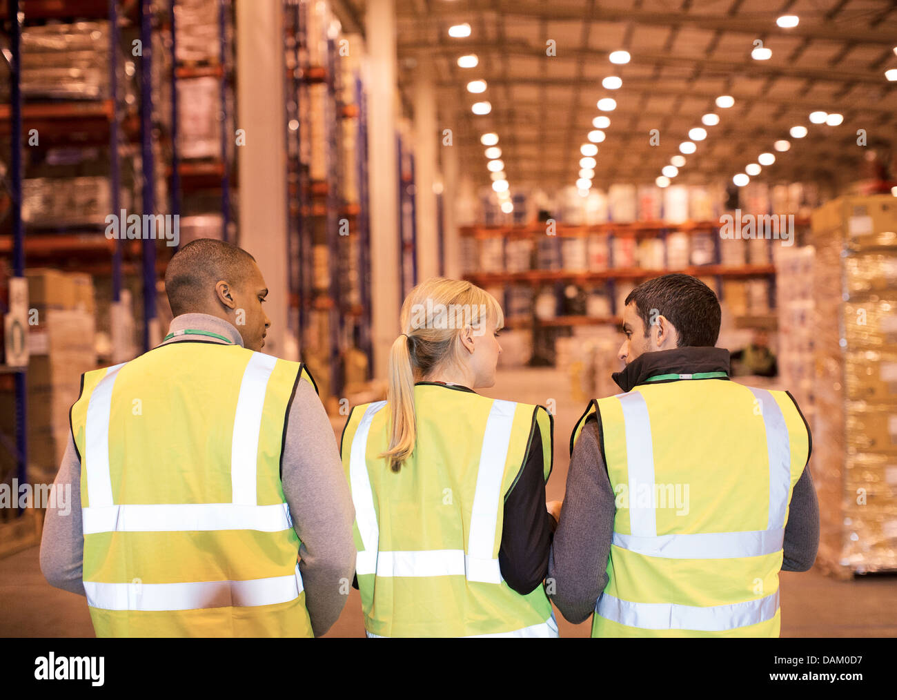 Workers talking in warehouse Stock Photo - Alamy