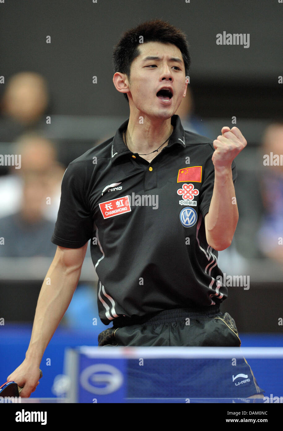 Zhang Jike of China reacts against Wang Liqin of China during the Men's ...