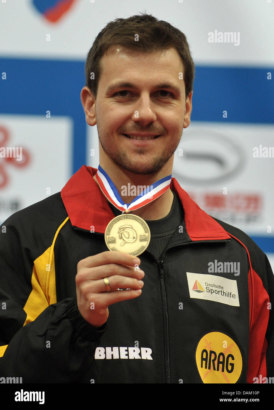 German Timo Boll poses with his bronze medal on the podium of the World ...