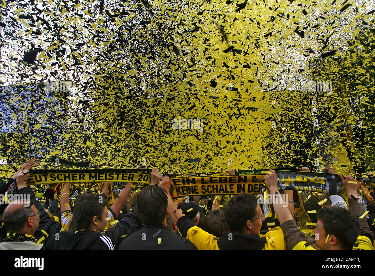 Dortmund's fans celebrate and cheer with confetti during the stage show ...