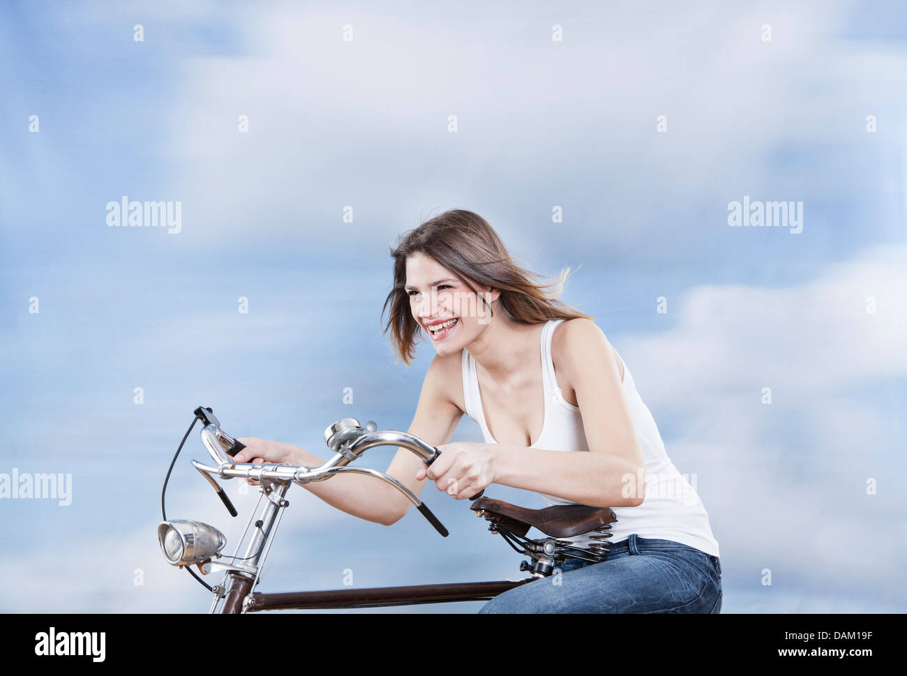 Germany, Cologne, Young woman riding bicycle, smiling Stock Photo - Alamy Germany, Cologne, Young woman riding bicycle, smiling Stock Photo - Alamy
